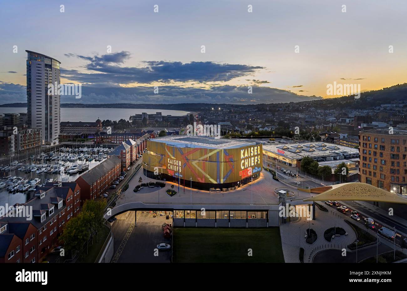 Aerial view of marina, bay and arena at dusk. Swansea Arena and Copr ...