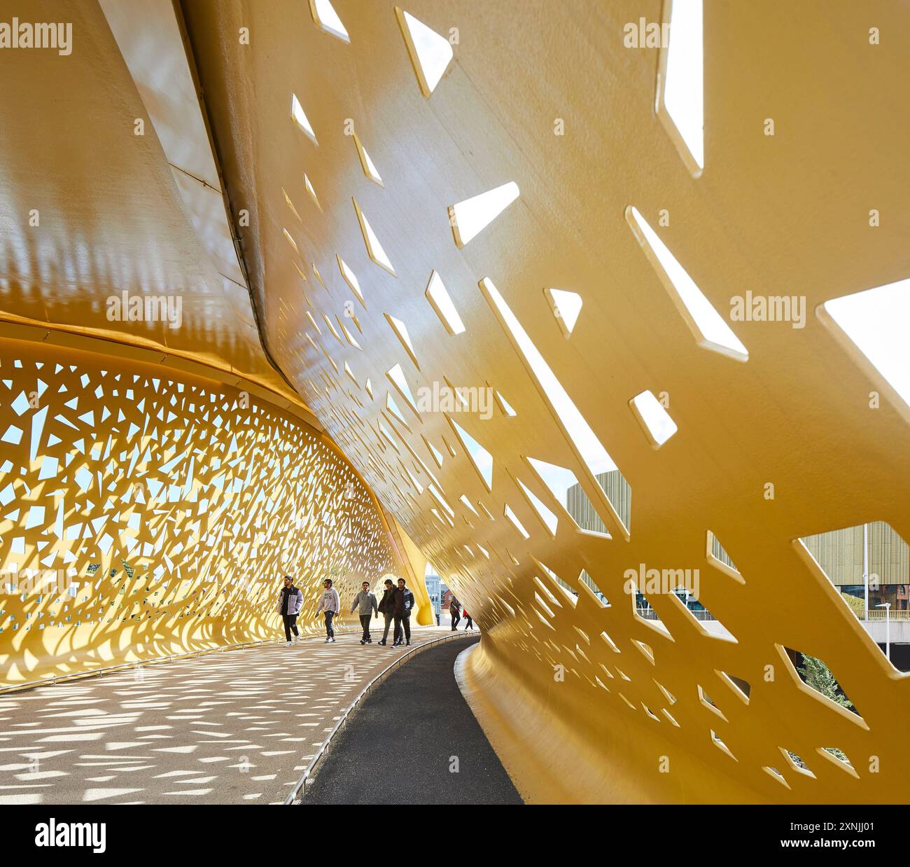 Perforated canopy of bicycle and pedestrian bridge. Swansea Arena and ...