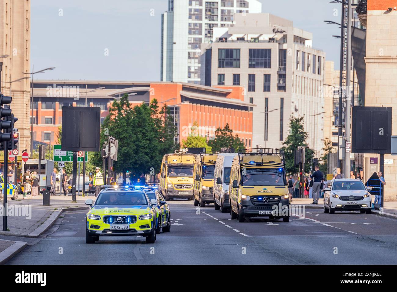 A prison van escorted by multiple police vehicles arrives at Liverpool ...