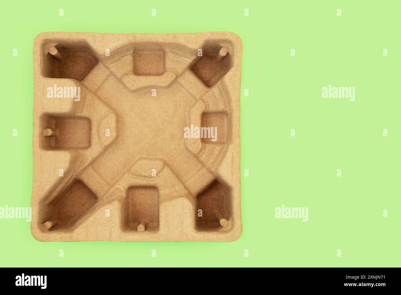 Cardboard delivery box insert on green background. Biodegradable ...