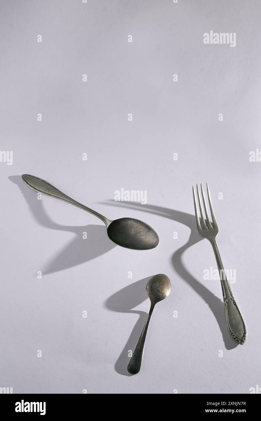 Abstract Silver Spoon and Fork Cutlery and shadows Stock Photo - Alamy