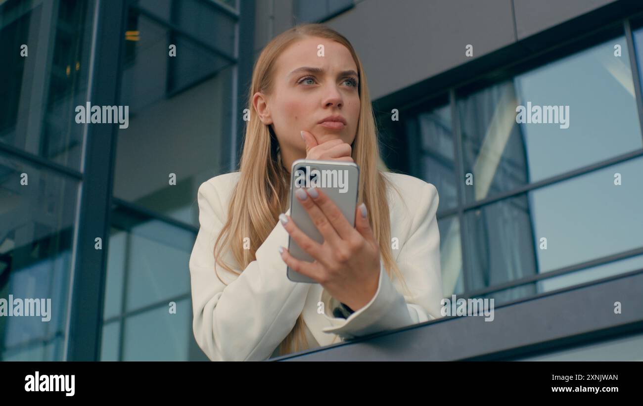 Pensive Caucasian woman business employer scroll mobile cellular phone ...