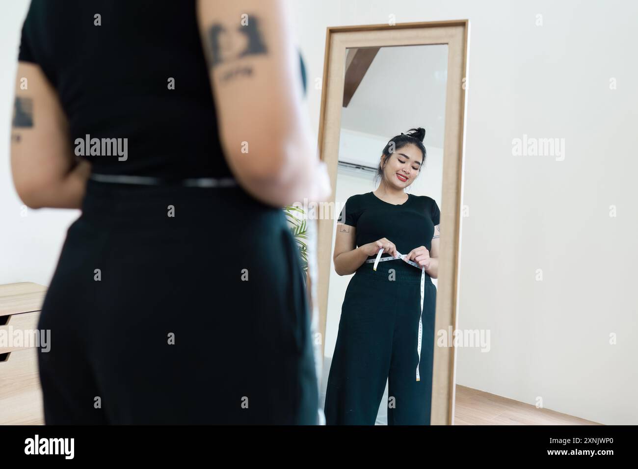 Confident Overweight Woman Measuring Waist in Front of Mirror for Body ...