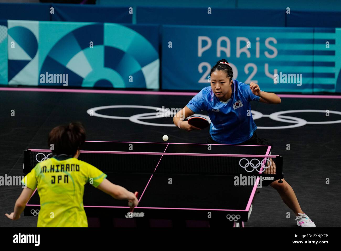 South Korea's Shin Yubin, background, plays against Japan's Miu Hirano ...