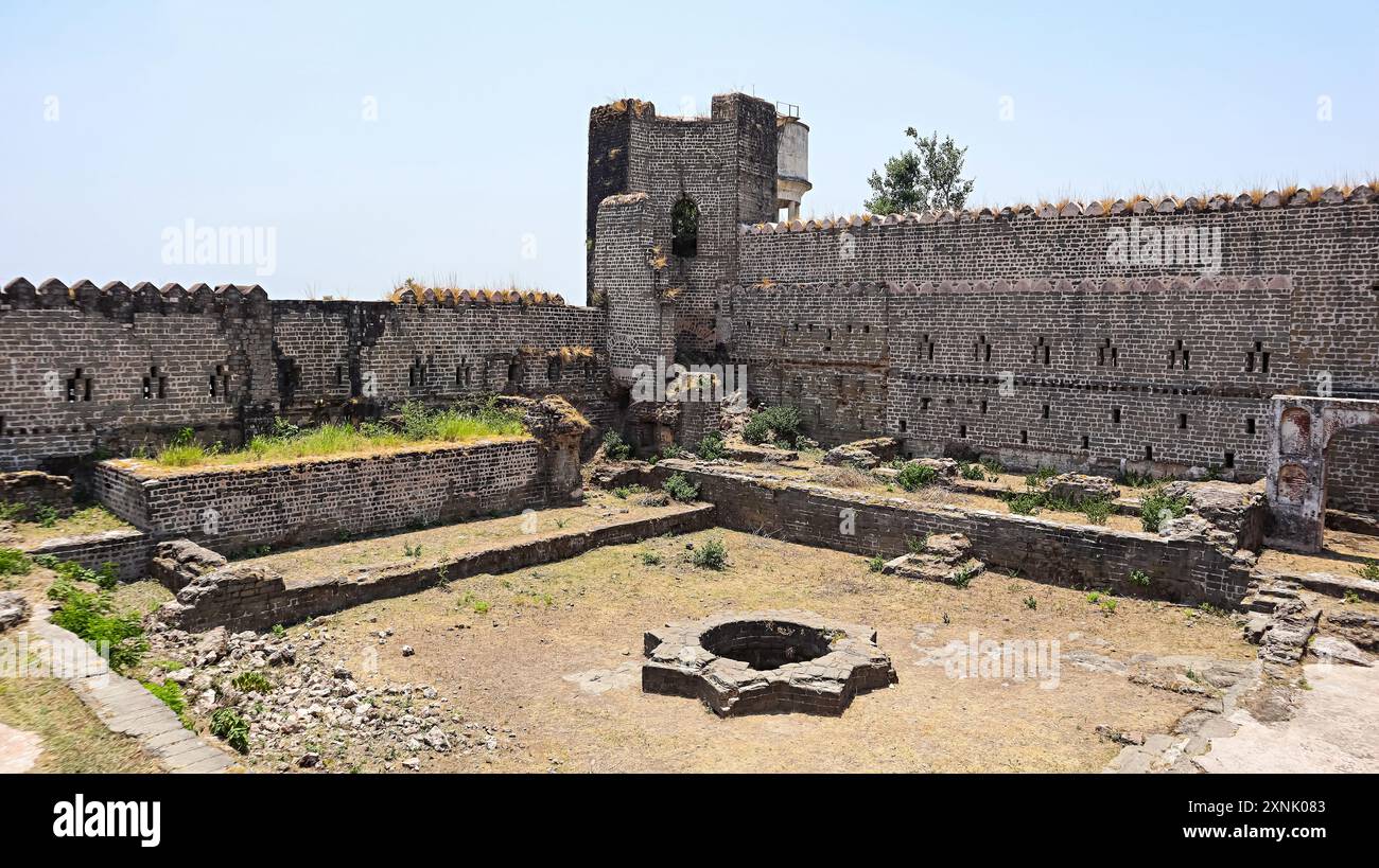 View of the ruined fortress of Nurpur Fort with a drinking water well ...