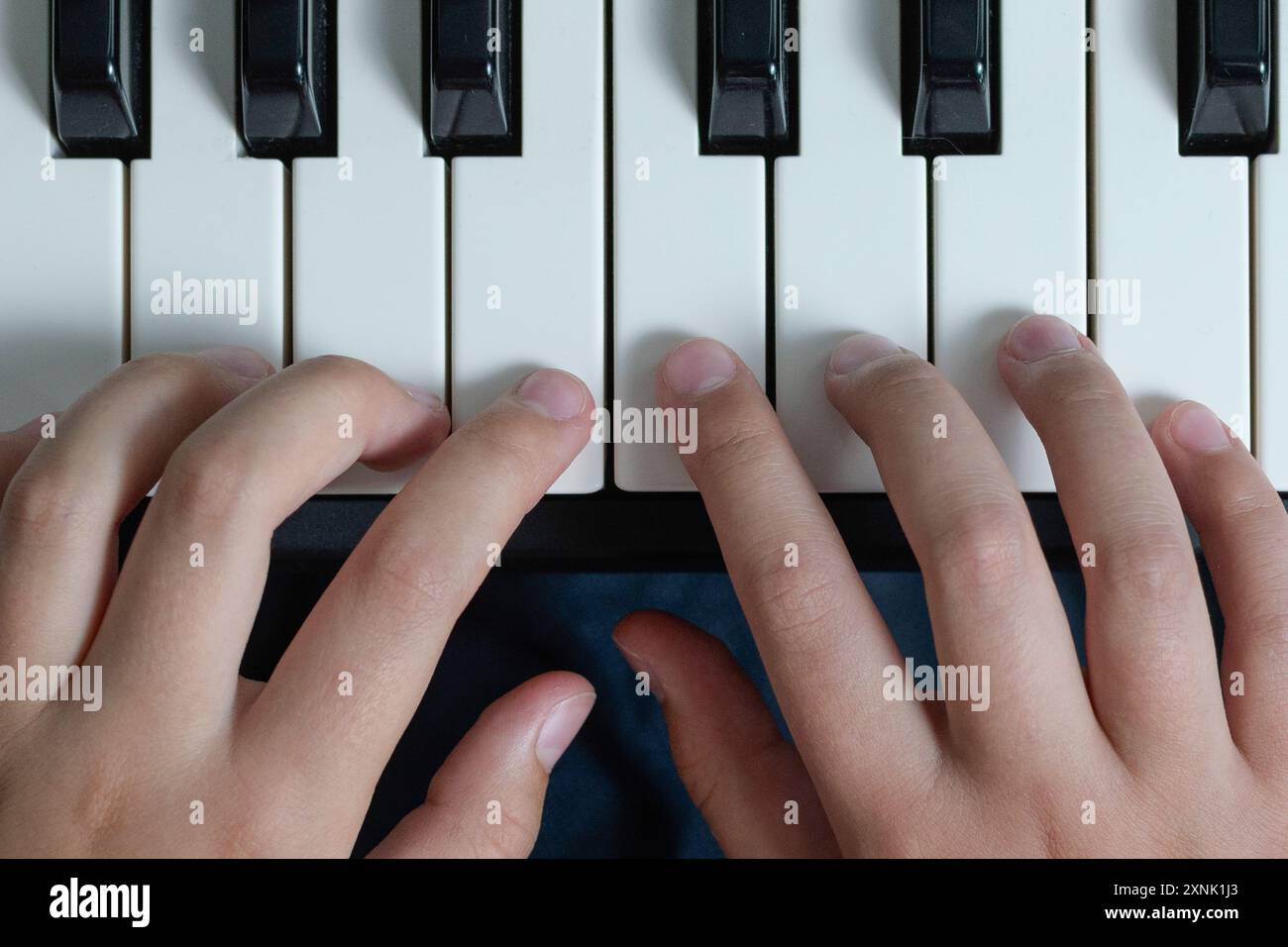 Piano chords and scales. Music exercises. Two hands playing. Close-up ...