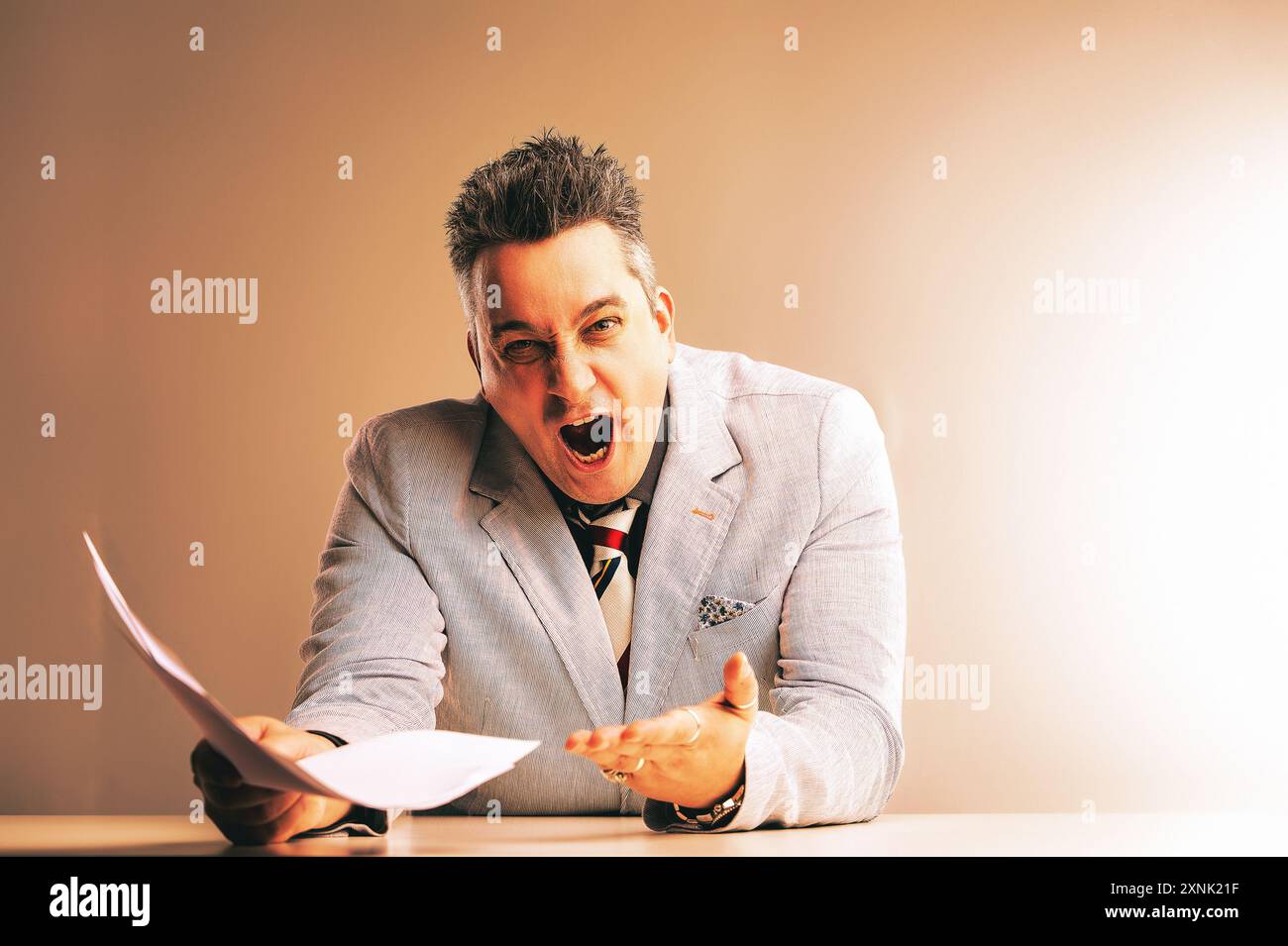 Businessman is experiencing extreme frustration, holding papers and ...