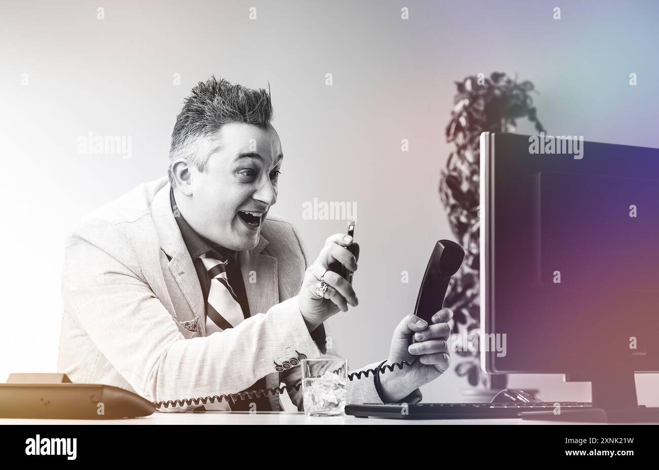 man in a light suit and striped tie holds a phone receiver and ...