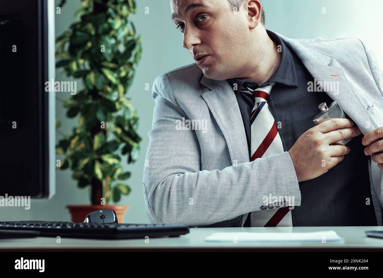 Hiding alcohol at work desk hi-res stock photography and images - Alamy