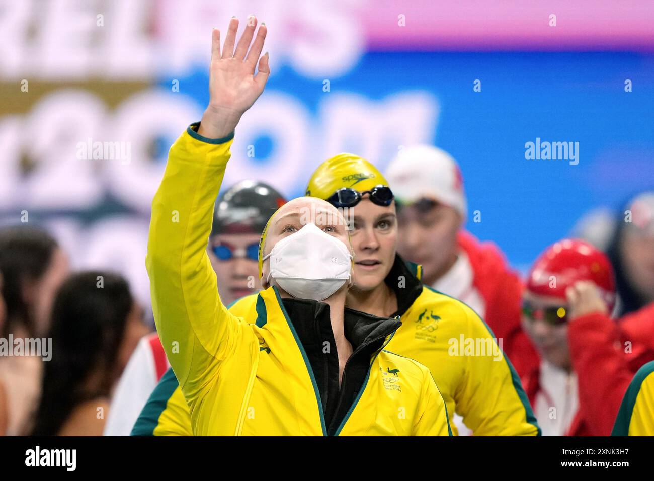 A member of Australia's women's 4x200-meter freestyle relay team waves before competing at the ...