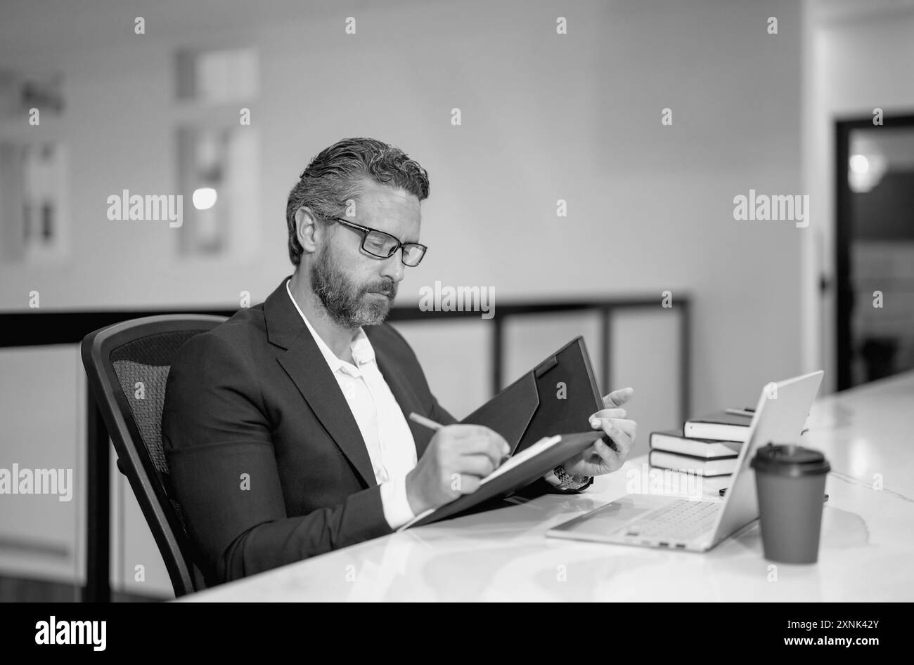 Handsome 40s business man working with laptop in office. Gray hair ...