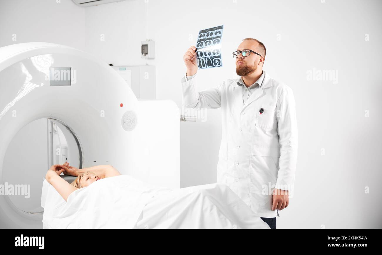 Medical computed tomography or MRI scanner. Doctor holding and ...