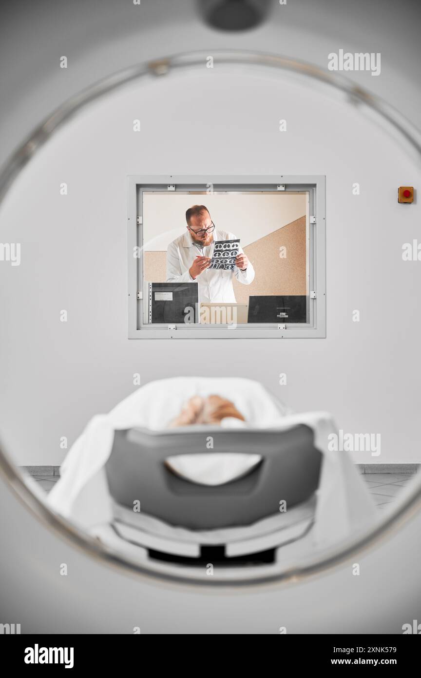 Medical computed tomography or MRI scanner. Doctor examining MRI ...