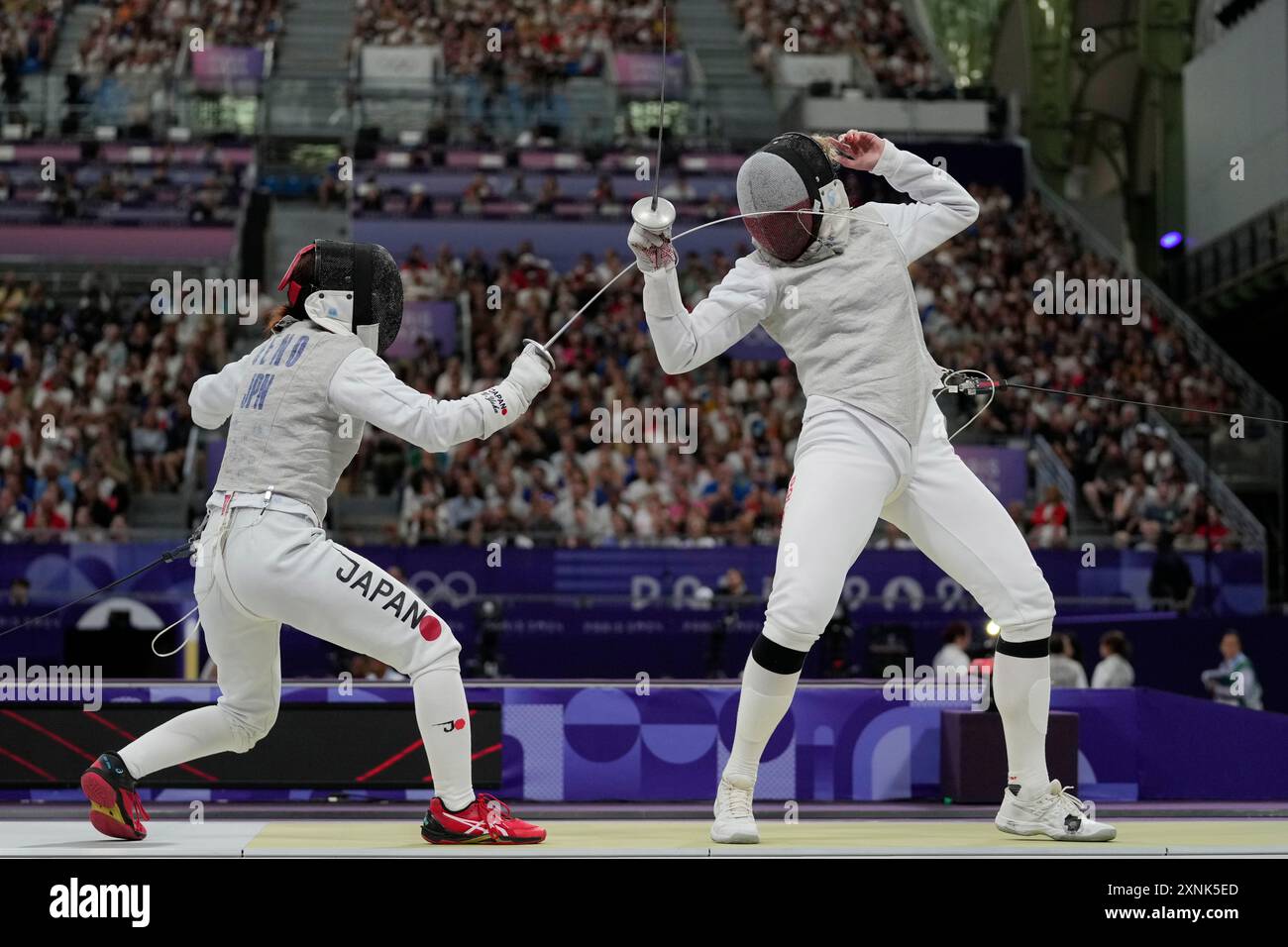 Japan's Yuka Ueno, left, competes with Poland's Julia Walczyk-Klimaszyk ...