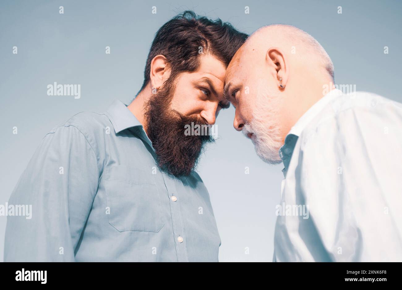 Father and son looking at each other. Retirement parent. Men generation ...