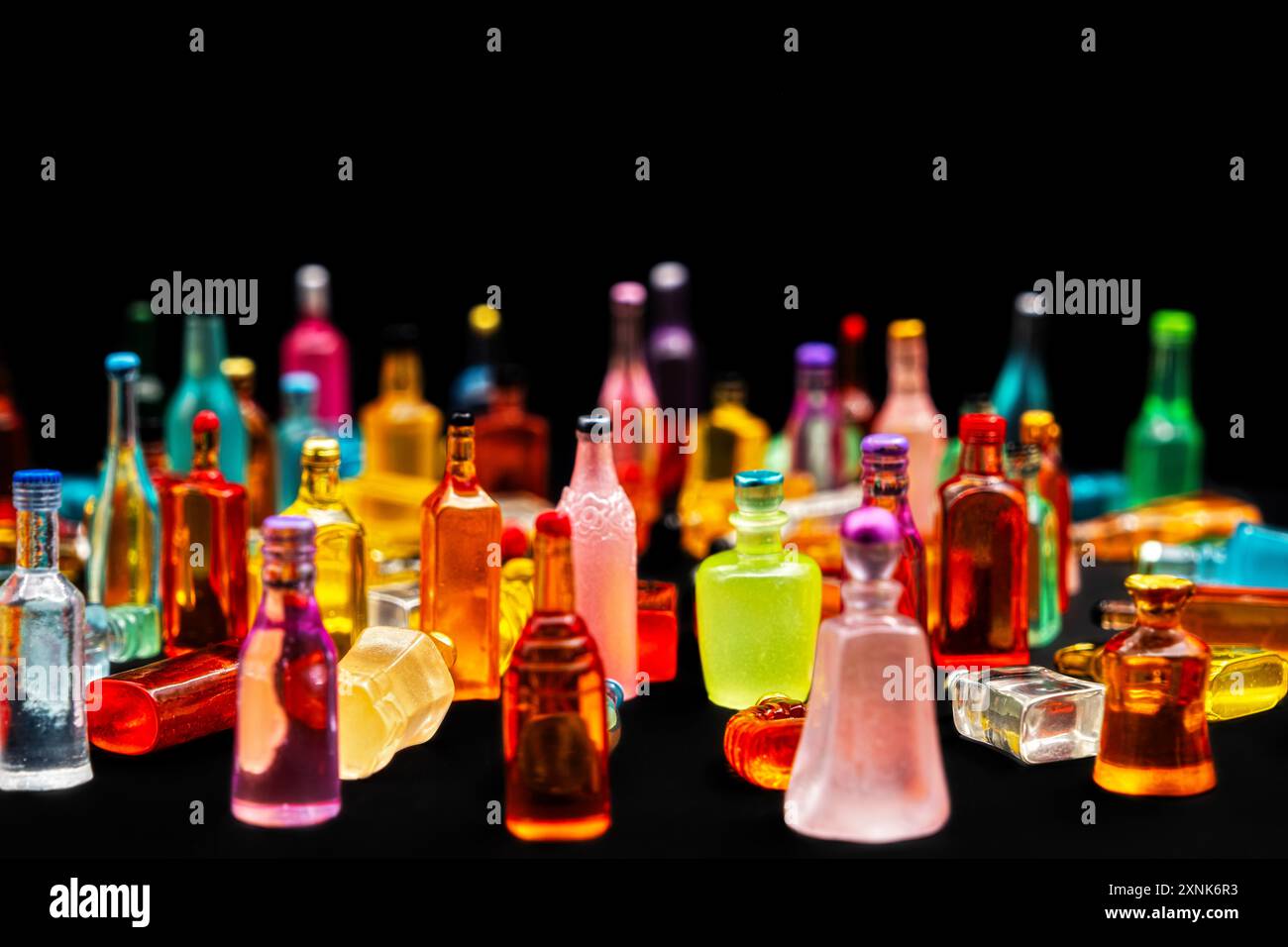 various miniature bottles of alcohol without labels with black ...