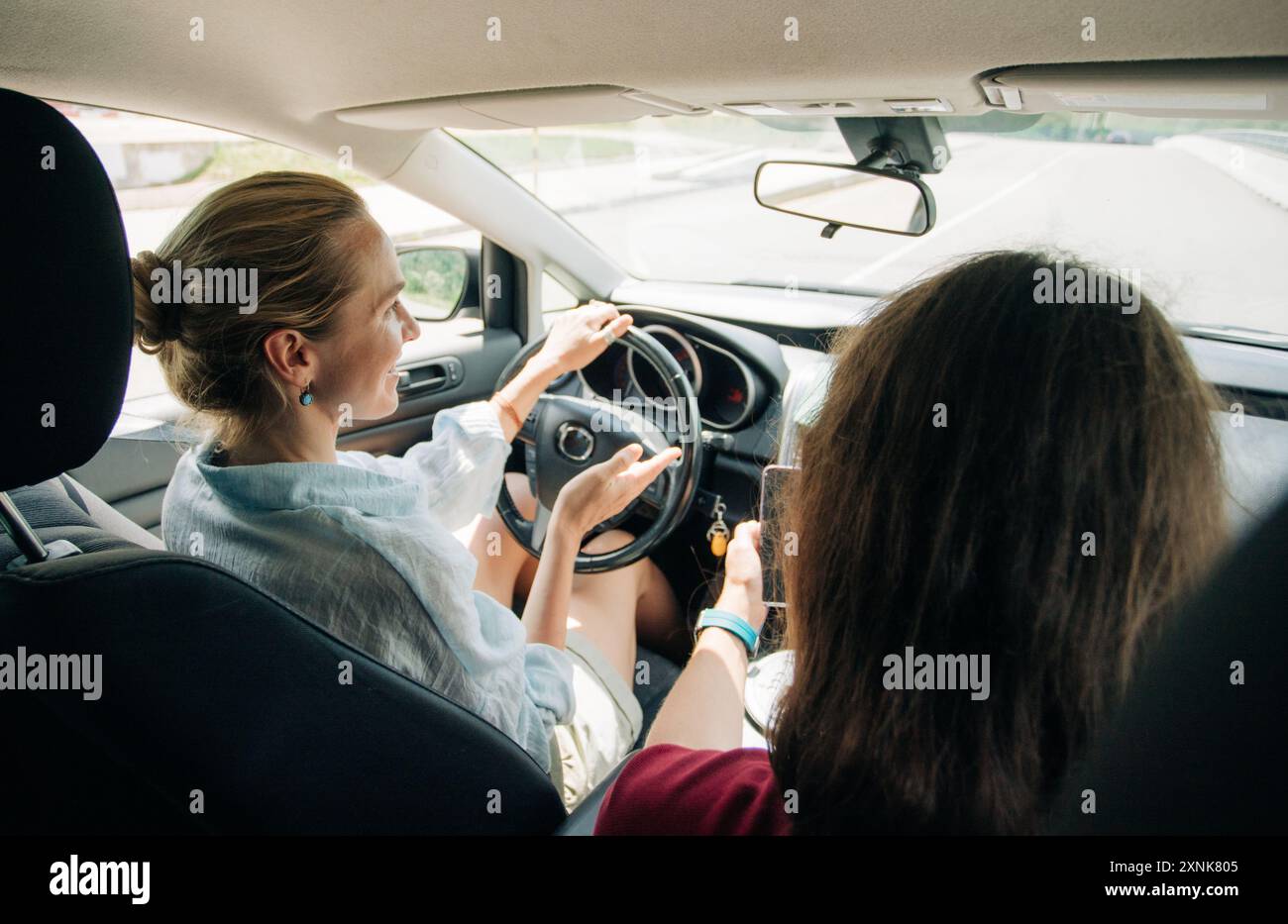 View inside the vehicle. Two women are driving a car Stock Photo - Alamy