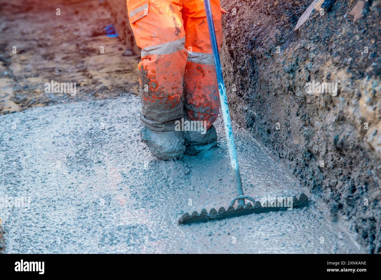 Concrete cast-in-place work. Builder leveling wet concrete. Concrete ...