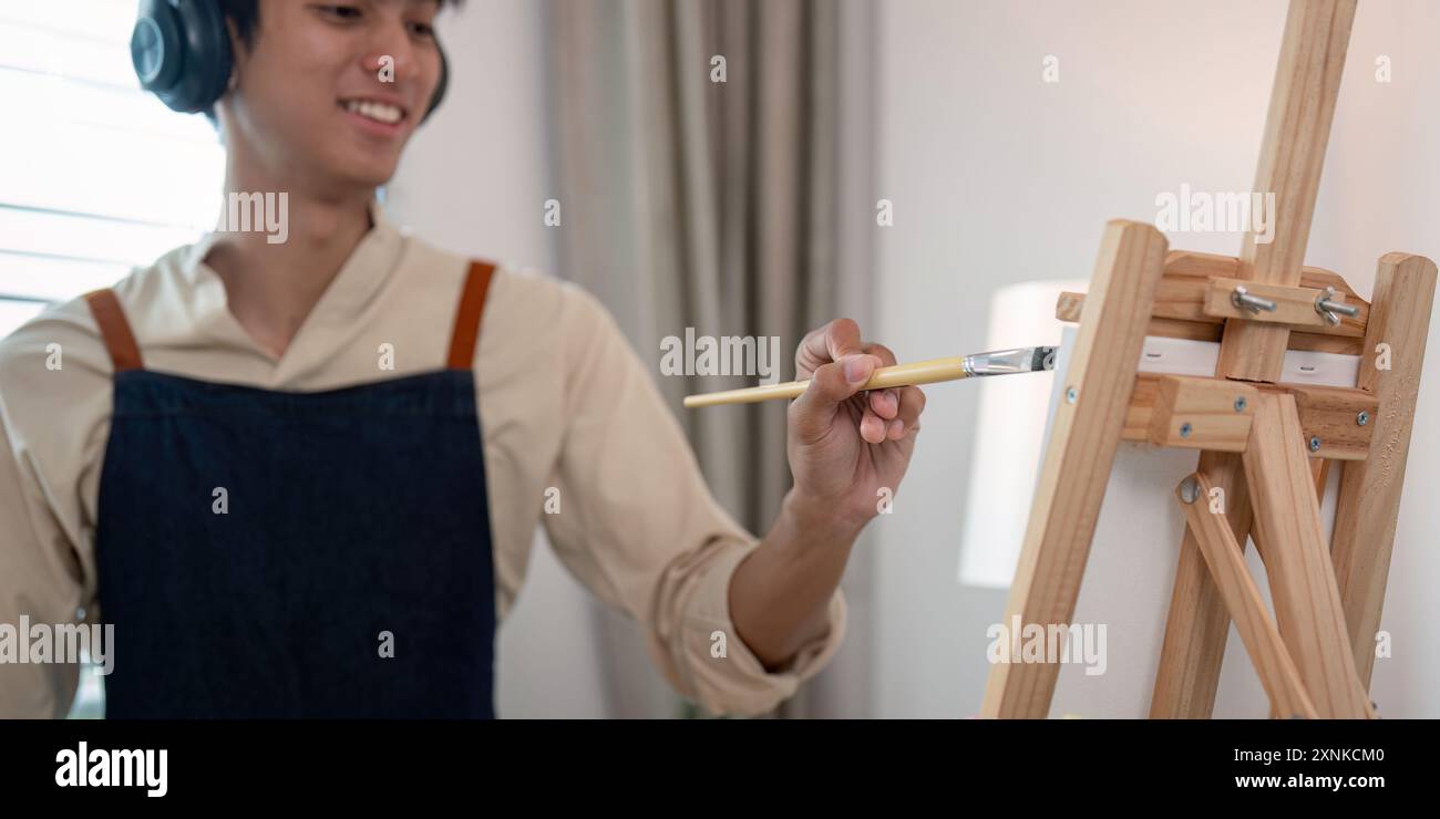 Young Artist Painting on Canvas at Home Studio Wearing Headphones and ...