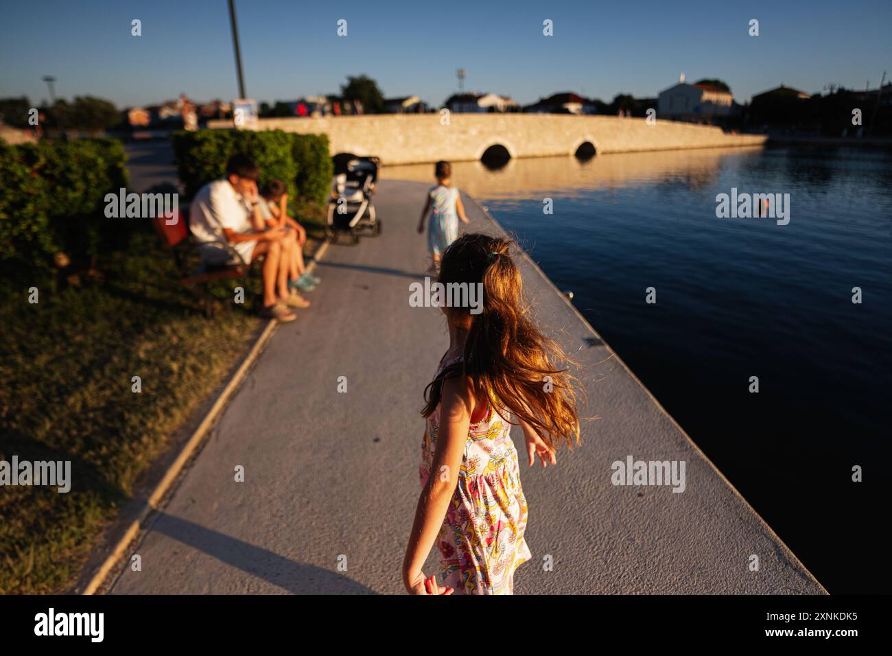 Kids enjoying outdoor activities by the river, with their family in the ...
