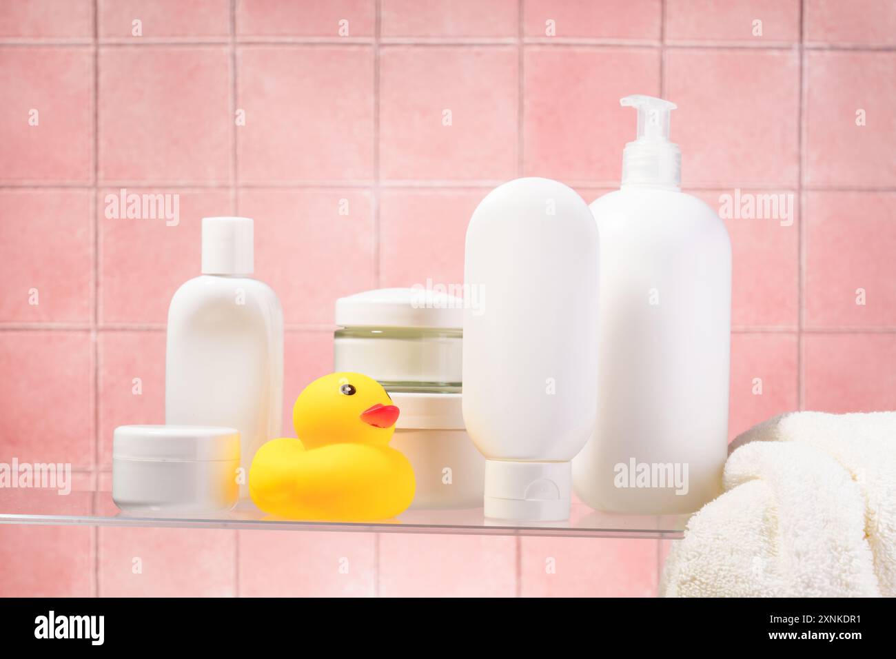 Bathroom with Cosmetic products at glass shelf Stock Photo - Alamy
