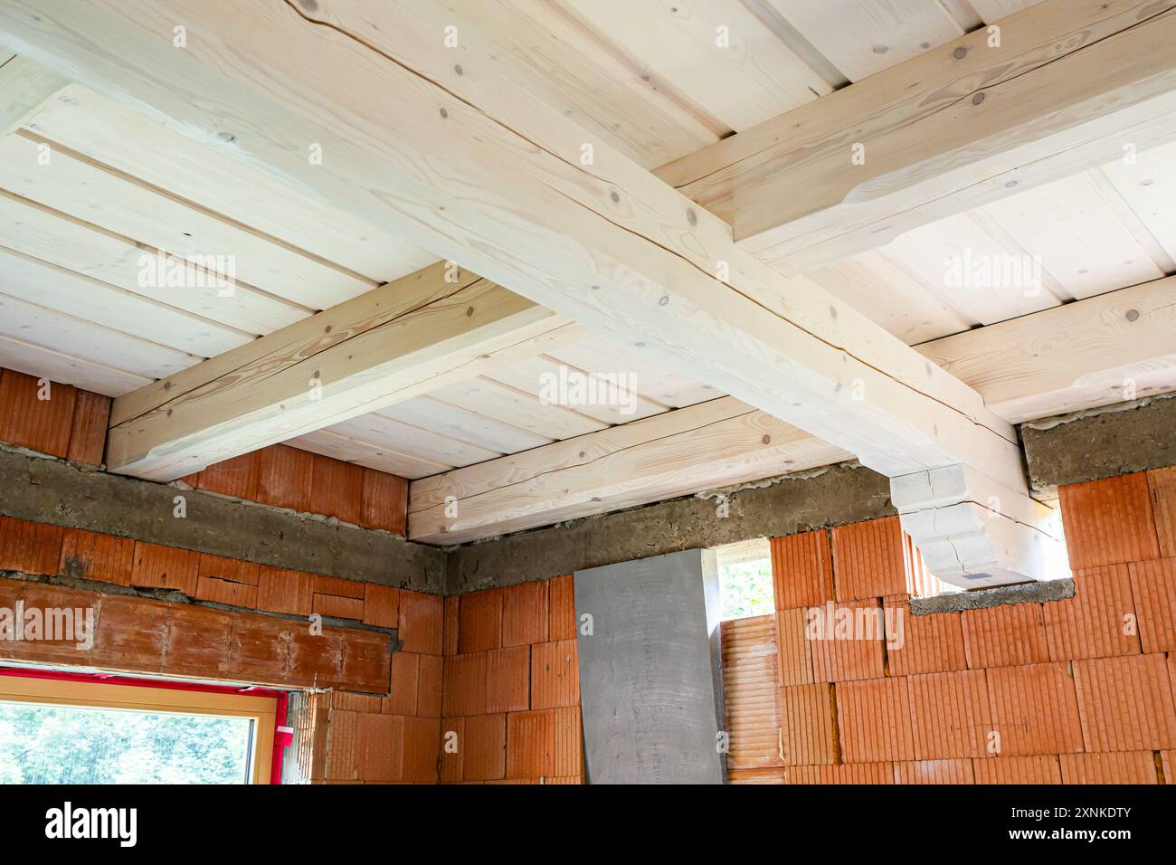 Construction of a ceiling with wooden structure and large wooden beams ...