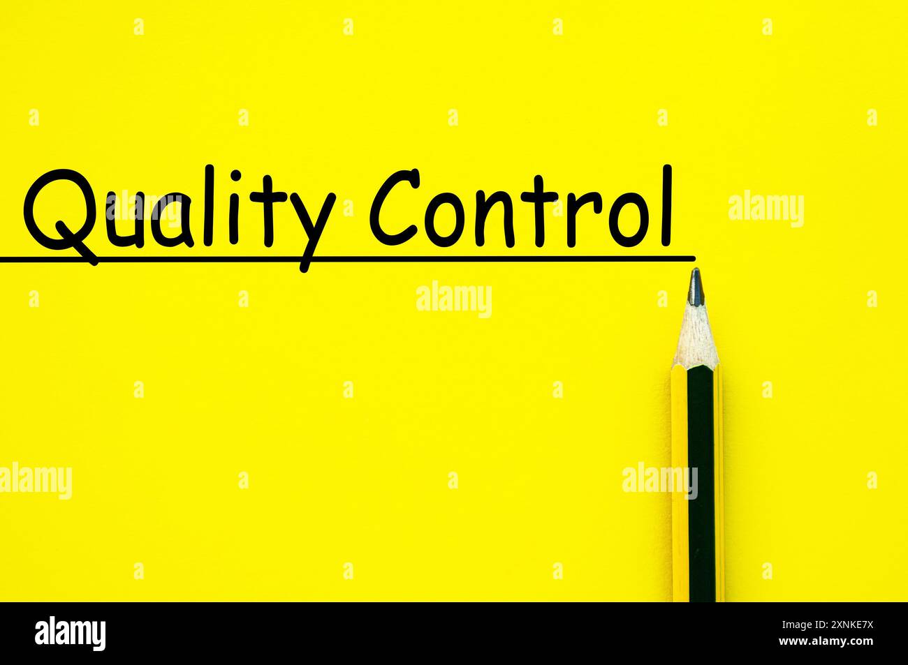 Quality control text written on yellow paper background Stock Photo - Alamy