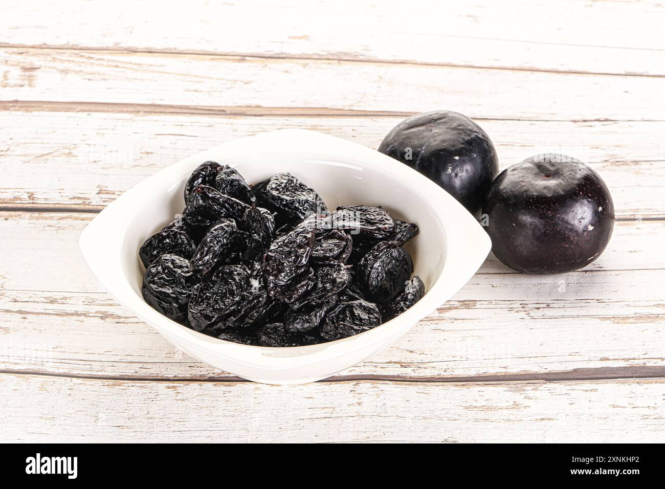 Dry sweet prunes in thw bowl Stock Photo - Alamy