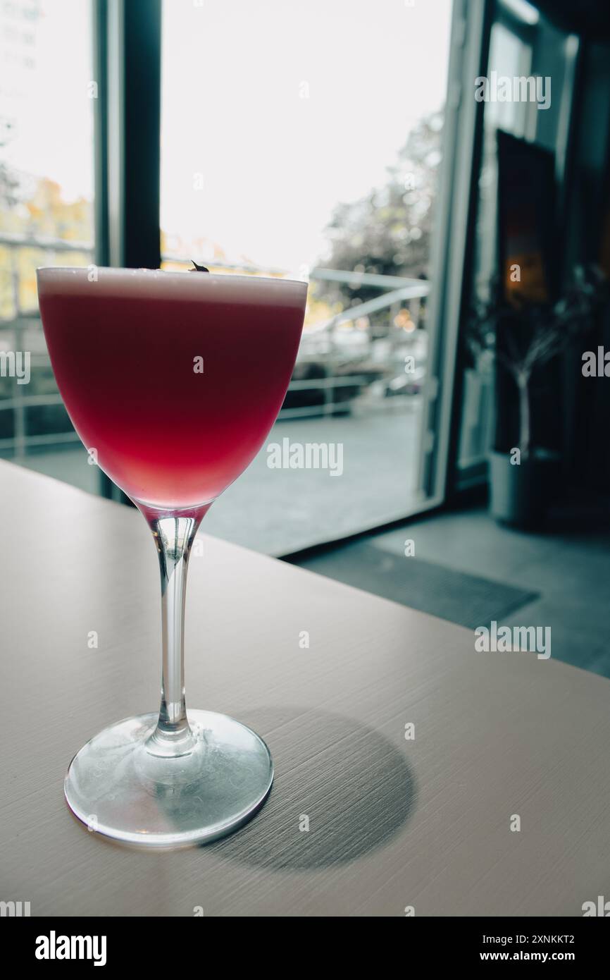 Cosmopolitan cocktail on the table. Elegant glass of red cocktail in ...