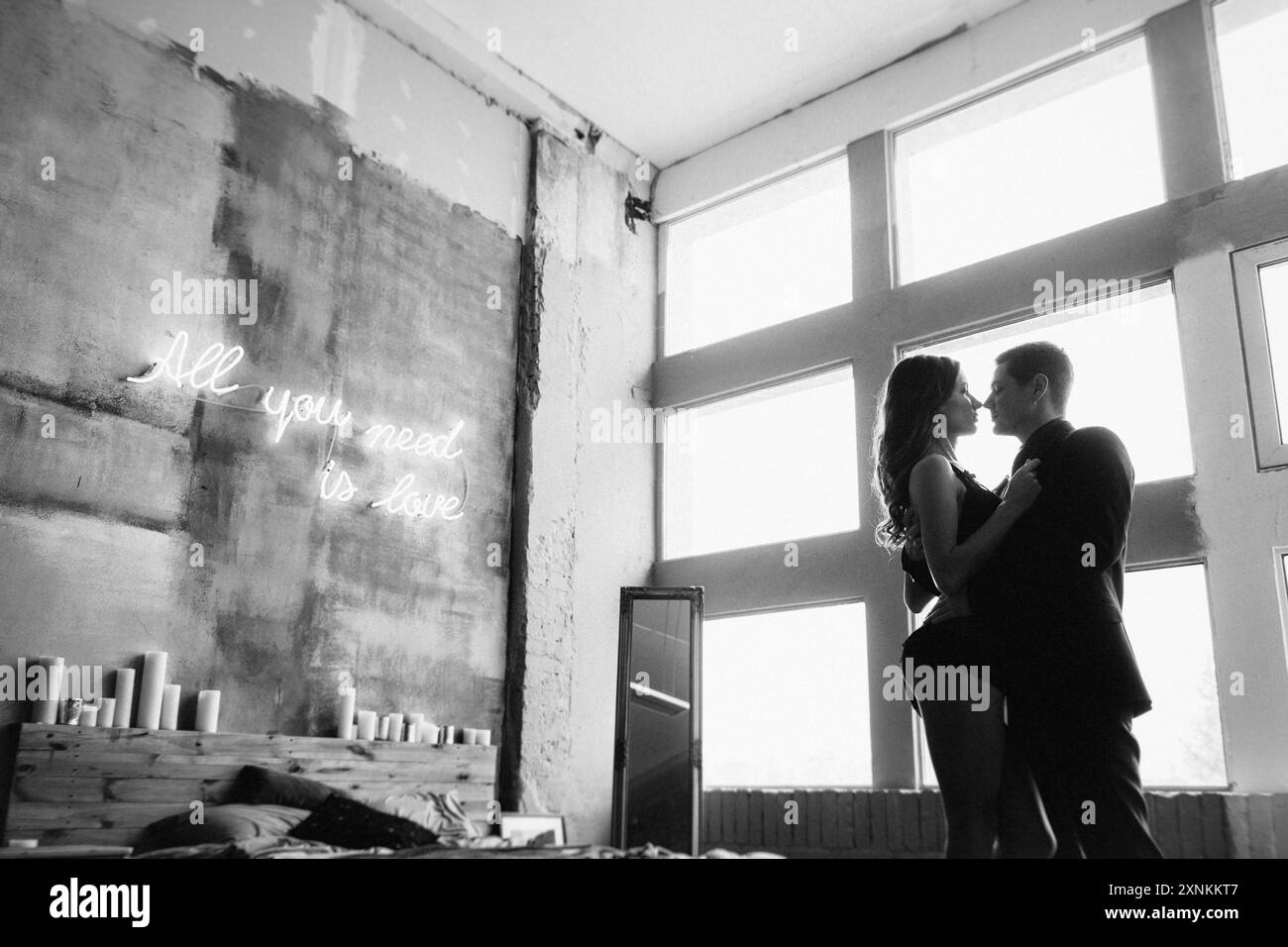 a guy and a girl hug each other, standing in the bed and window Stock ...