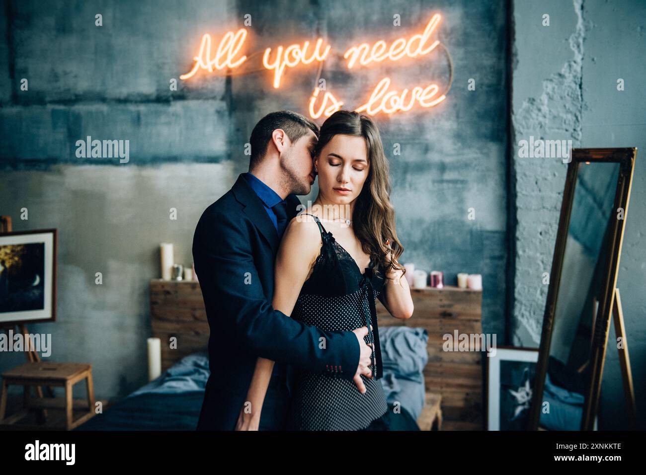 a guy and a girl hug each other, standing in the bed and window Stock ...
