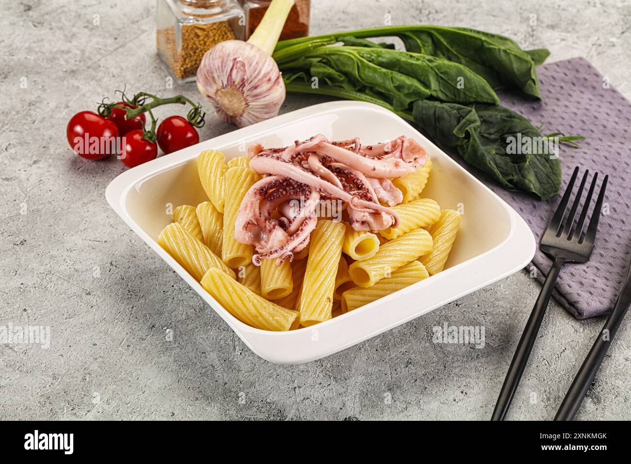 Italian cuisine - pasta tortiglioni with squid tentacles Stock Photo ...