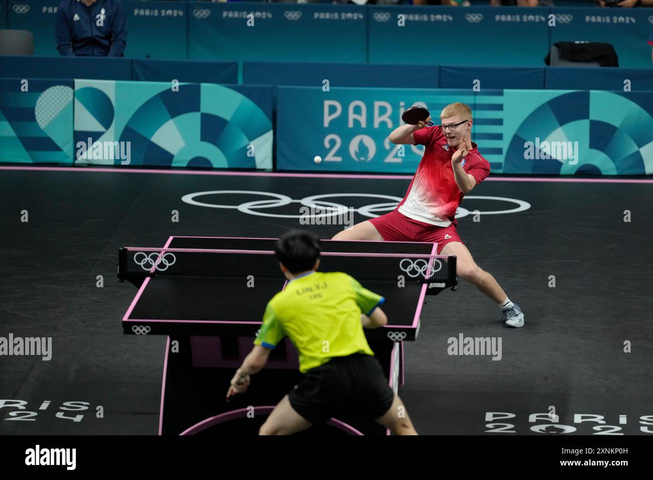 France's Felix Lebrun, background, plays against Taiwan's Lin Yun-Ju ...