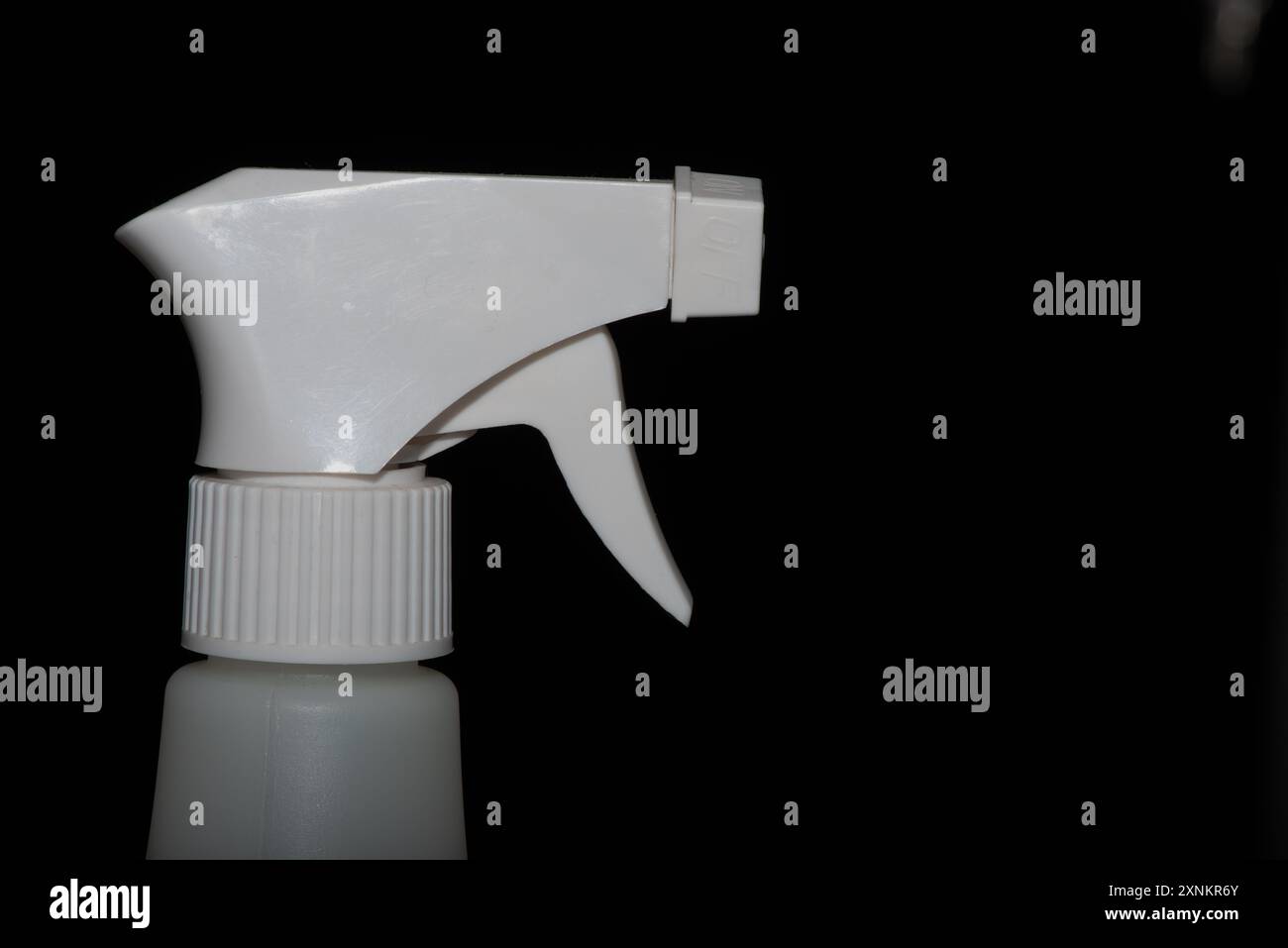 A close-up photo of the head of a spray bottle, highlighting the nozzle ...