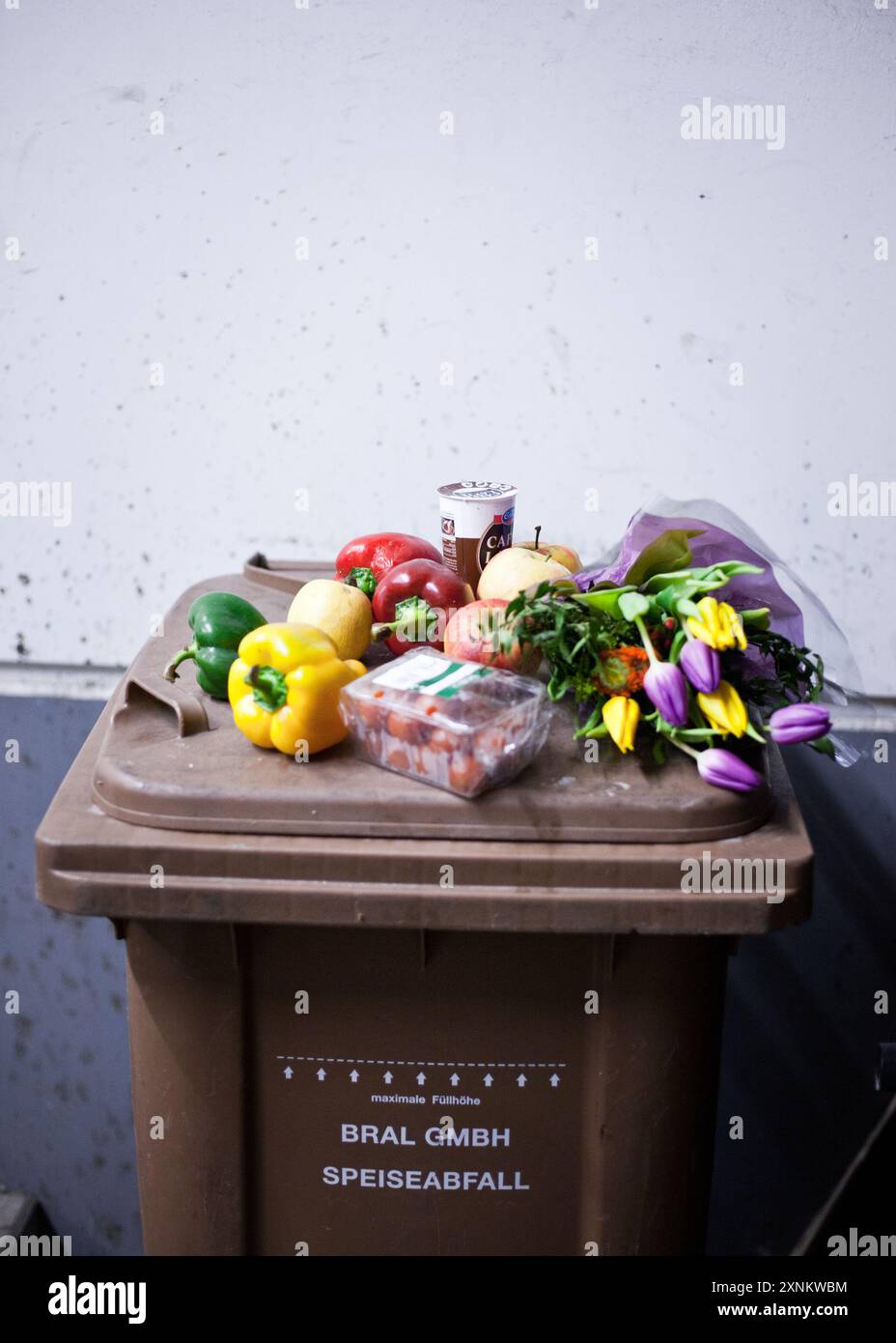 A collection of fresh fruits, vegetables, and flowers placed on top of ...