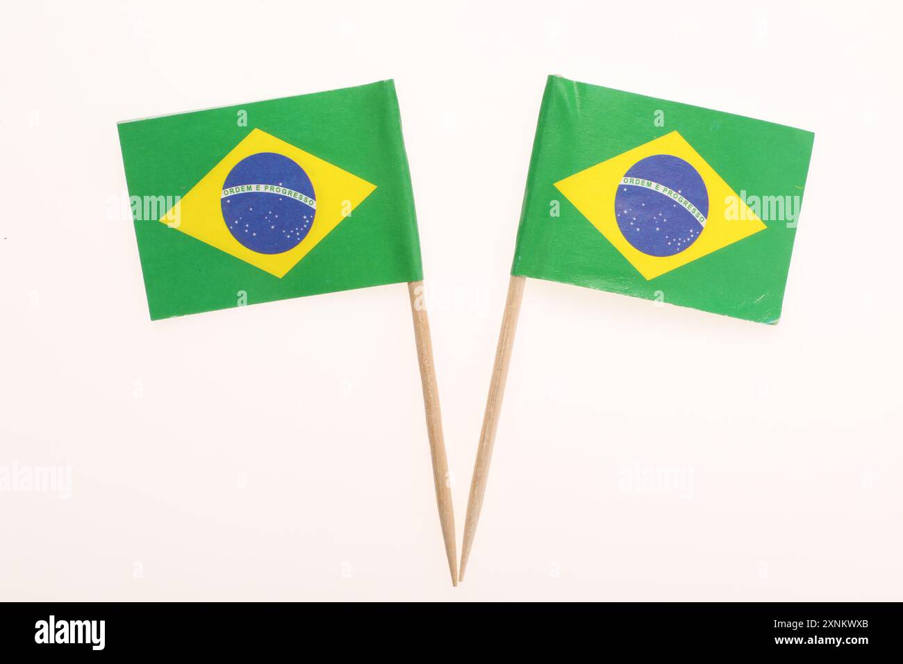 Small paper flags of Brazil isolated on white Stock Photo - Alamy