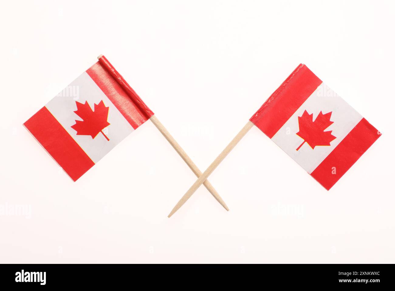 Small paper flags of Canada isolated on white Stock Photo - Alamy