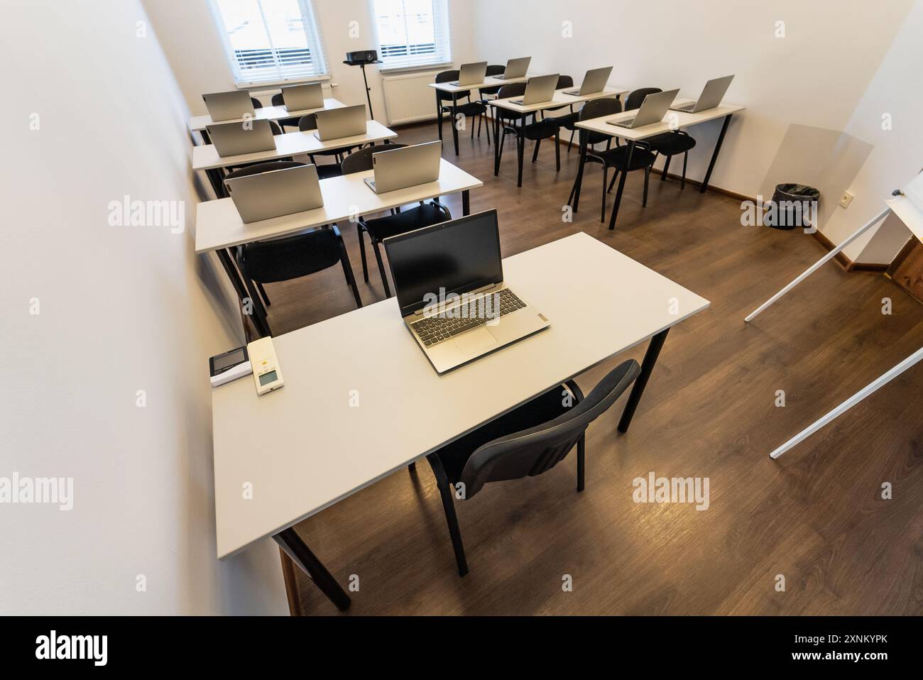 Interior of a modern classroom with desks, chairs and laptops. Empty ...