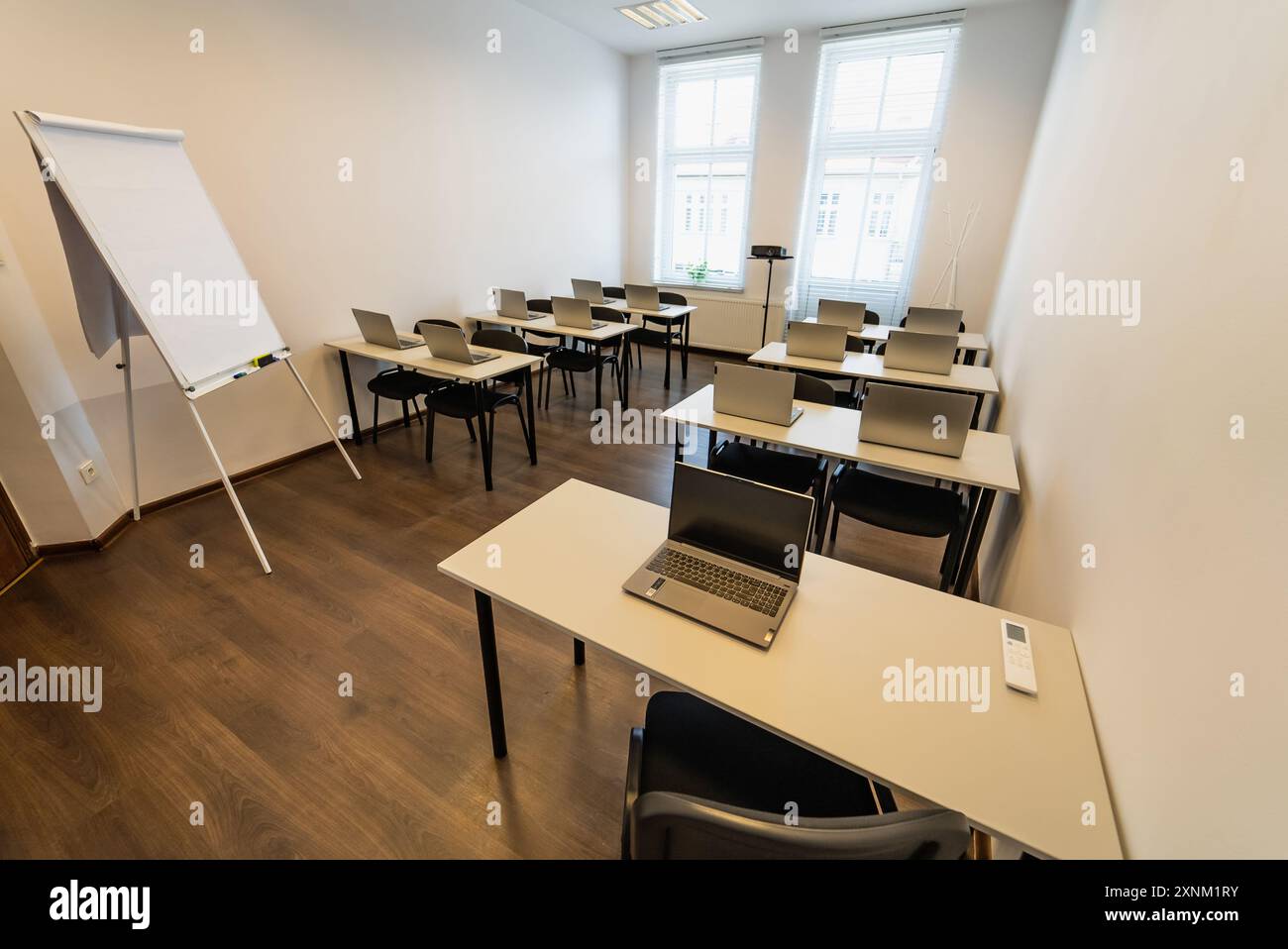 Interior of a modern classroom with desks, chairs and laptops. Empty ...