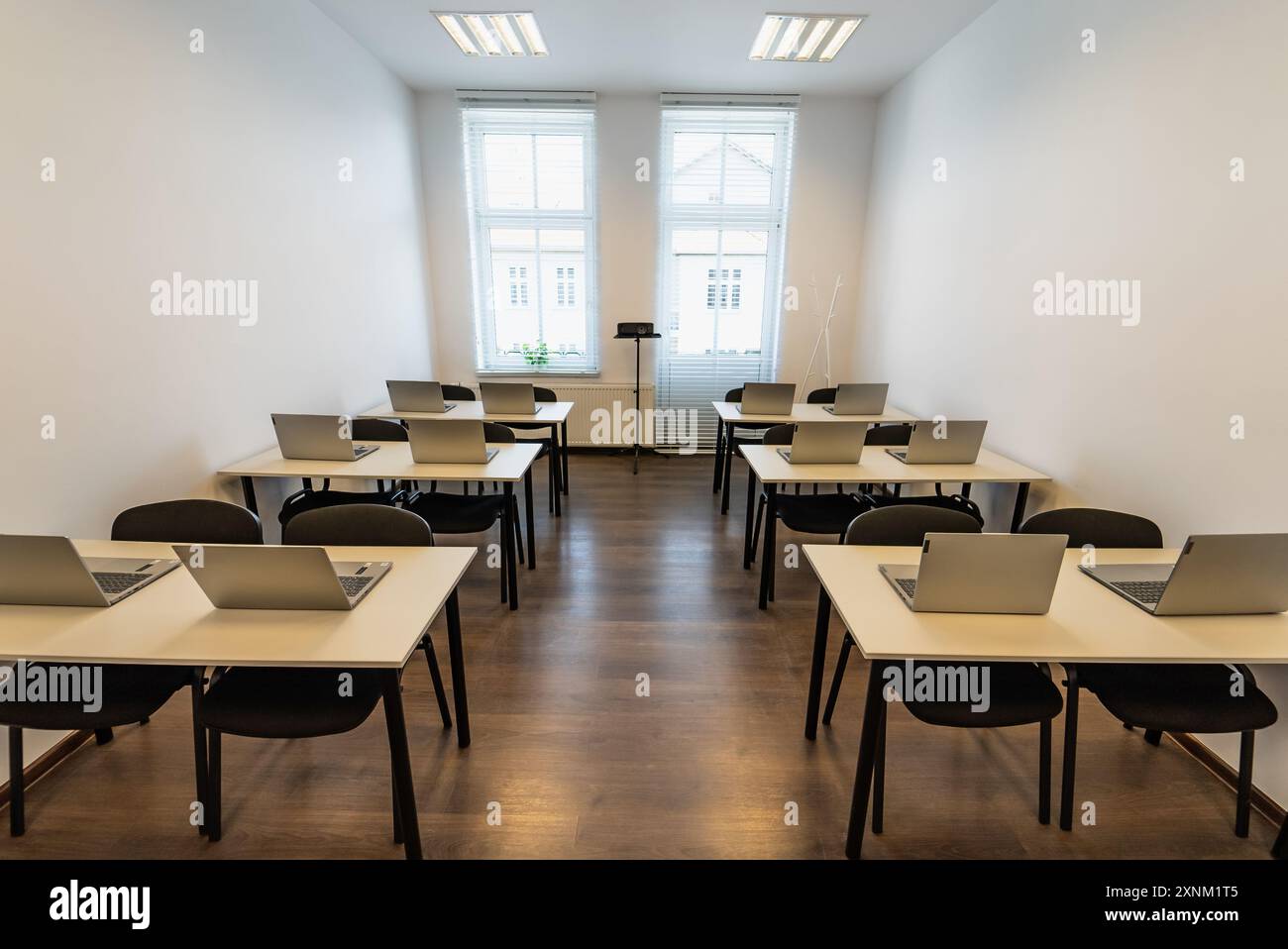 Interior of a modern classroom with desks, chairs and laptops. Empty ...