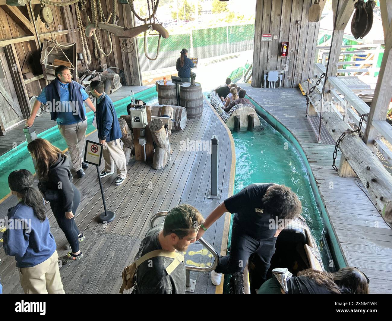 Ride attendants assisting visitors at the entrance to Loggers Revenge ...
