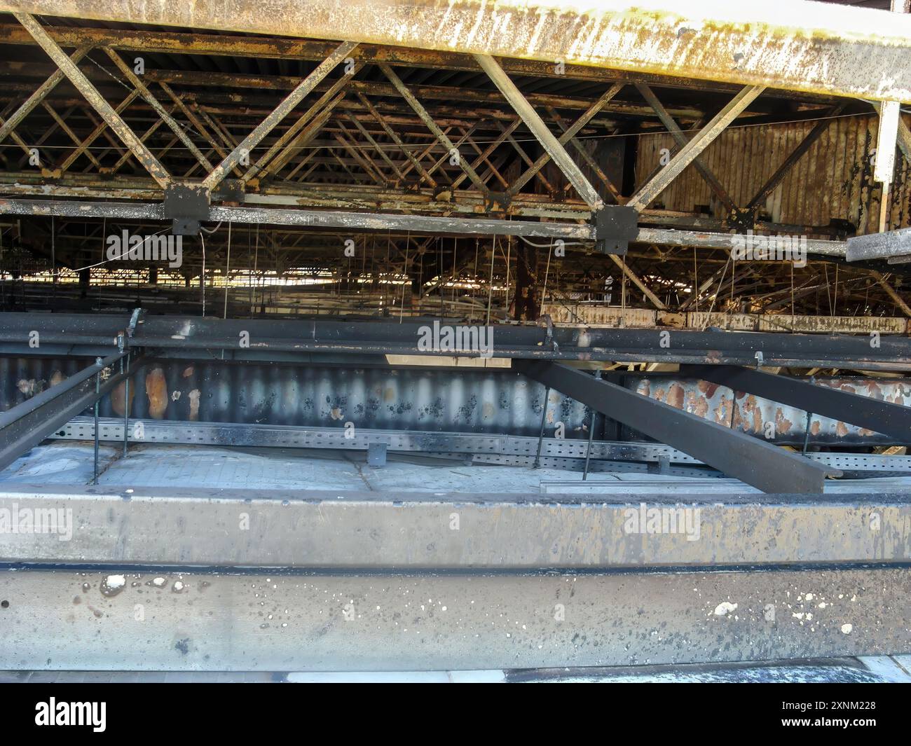 Burnt load-bearing structures inside a warehouse, showing significant ...