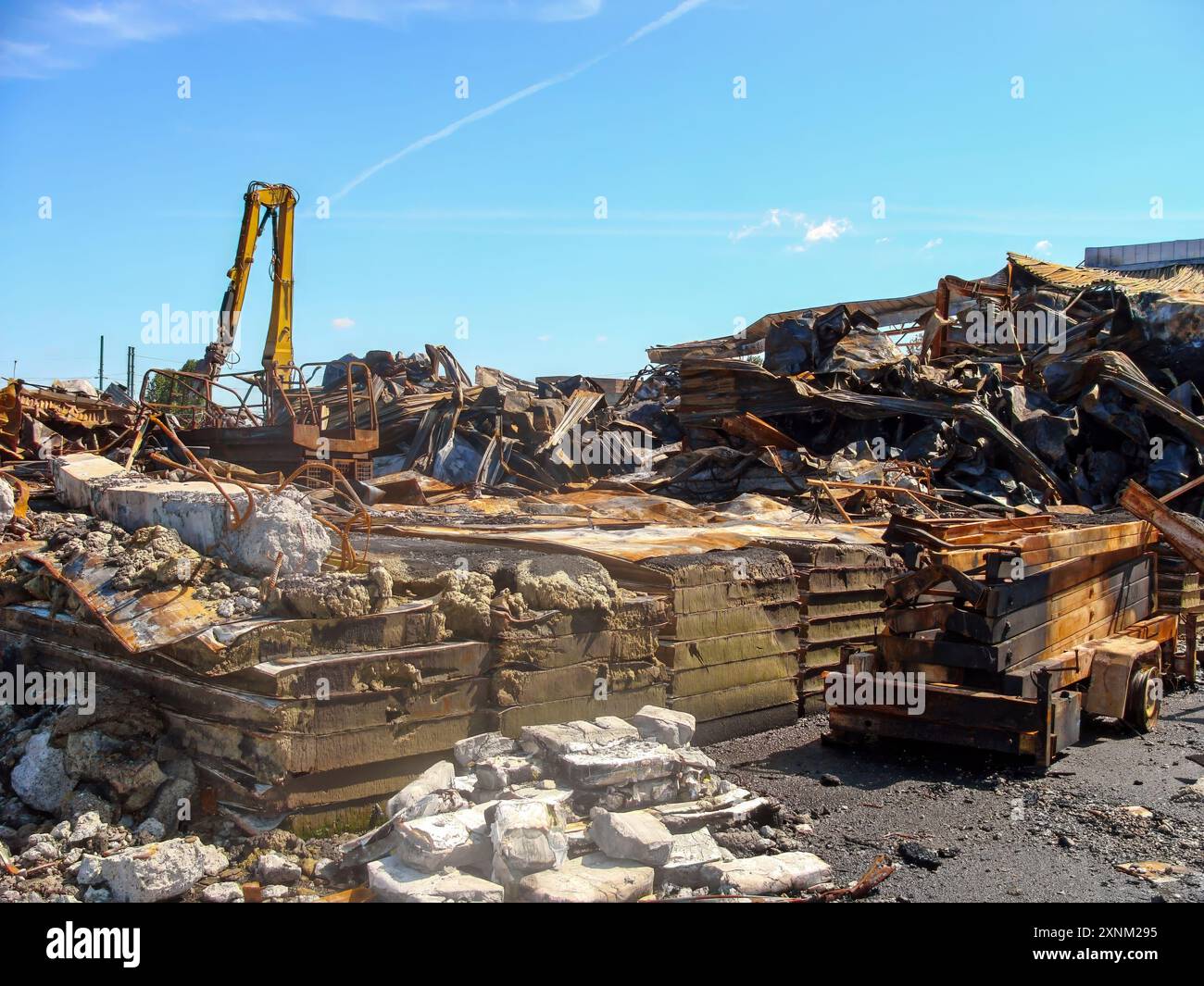 Burnt remains of an industrial site after a fire, with debris and ...