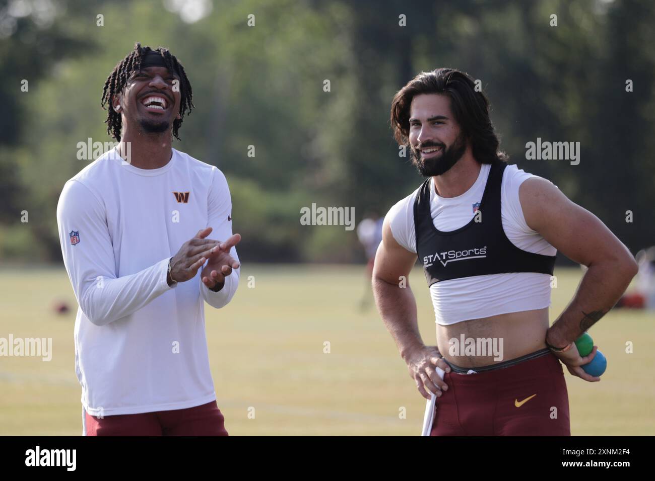 Washington Commanders quarterbacks Jayden Daniels, left, and Sam ...