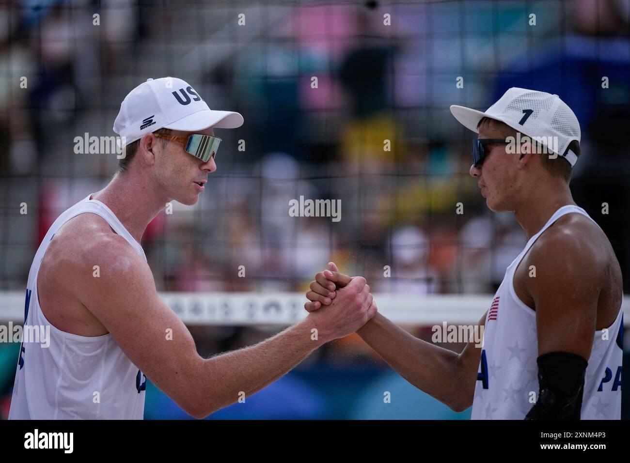 US' Miles Partain, right, and Andrew Benesh react during the men's pool D beach volleyball match ...