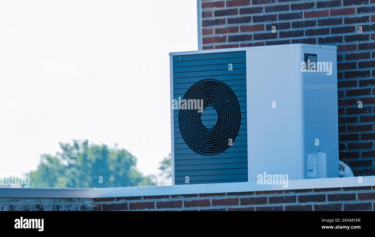 A modern air source heat pump efficiently perched on a rooftop ...