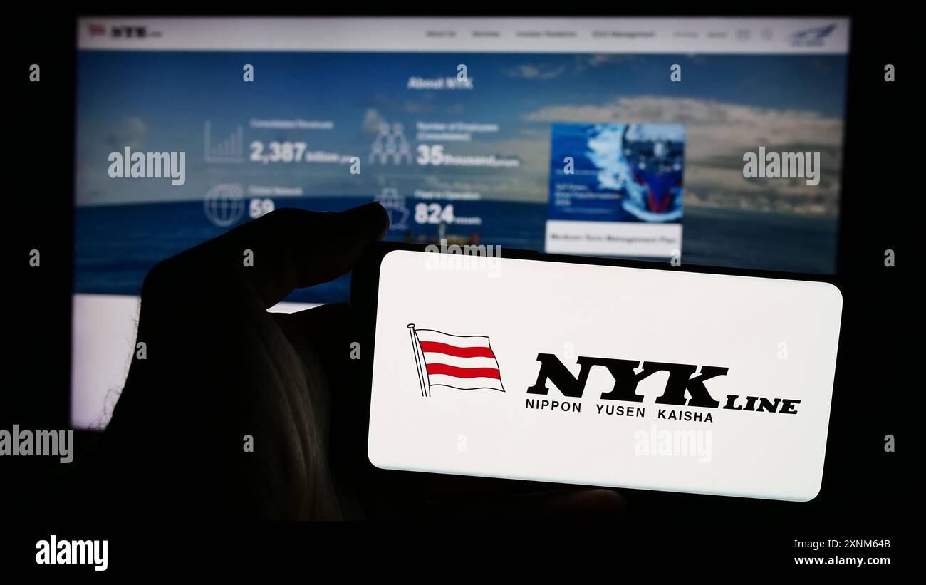 Person holding smartphone with logo of company Nippon Yusen Kabushiki ...