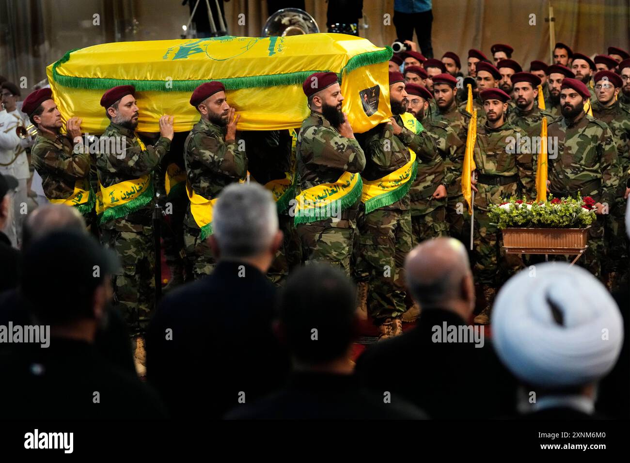 Hezbollah fighters carry the coffin of their top commander Fouad Shukur ...
