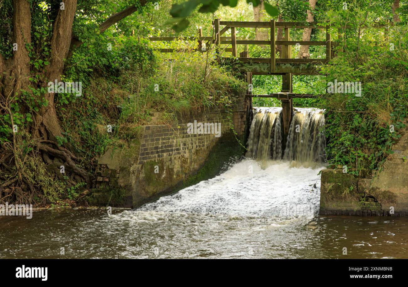 Lower Peover, Knutsford, Cheshire, UK - July 30th 2024 - Water pouring ...