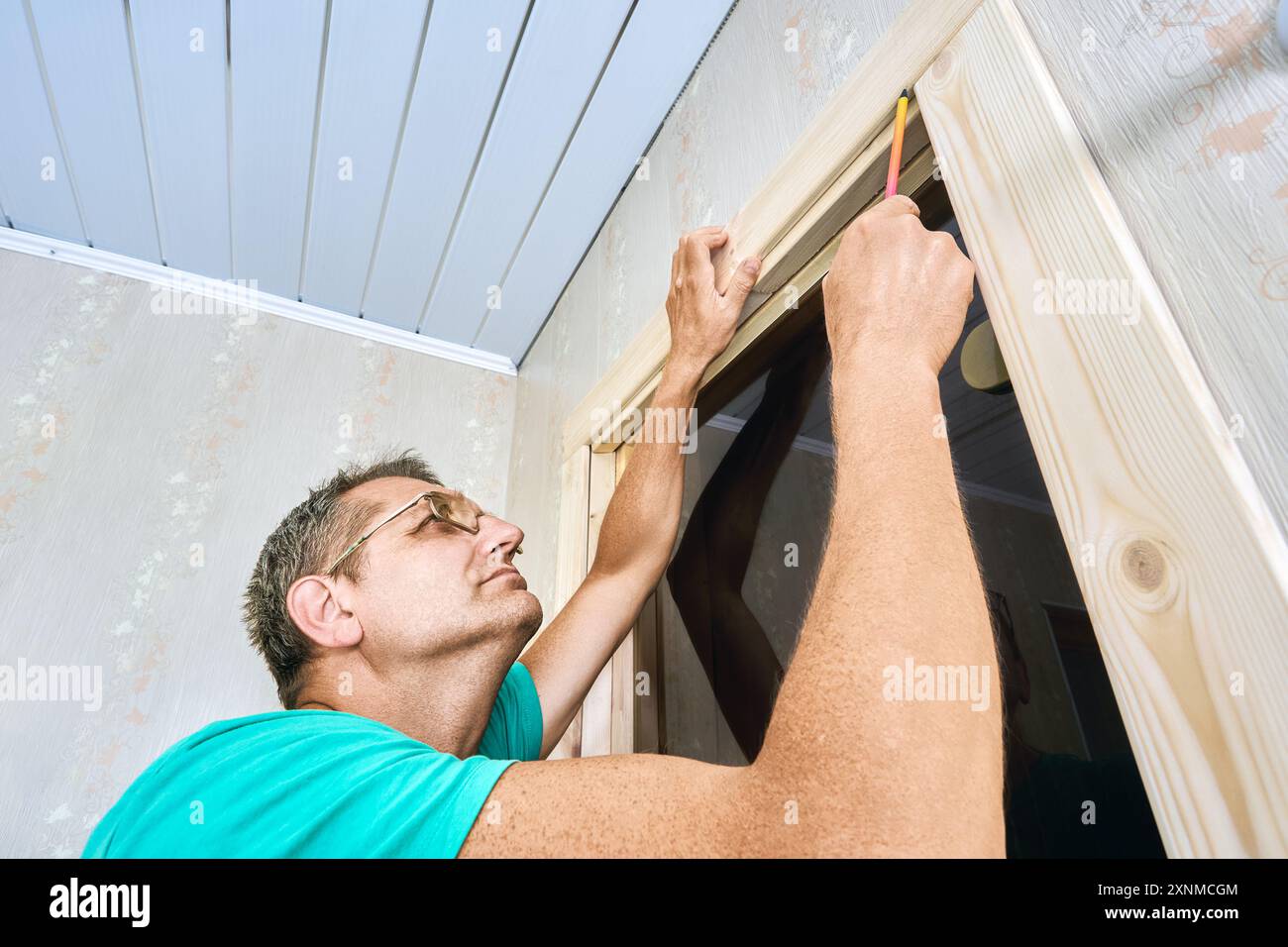 Installing door frame, marking casing using pencil Stock Photo - Alamy